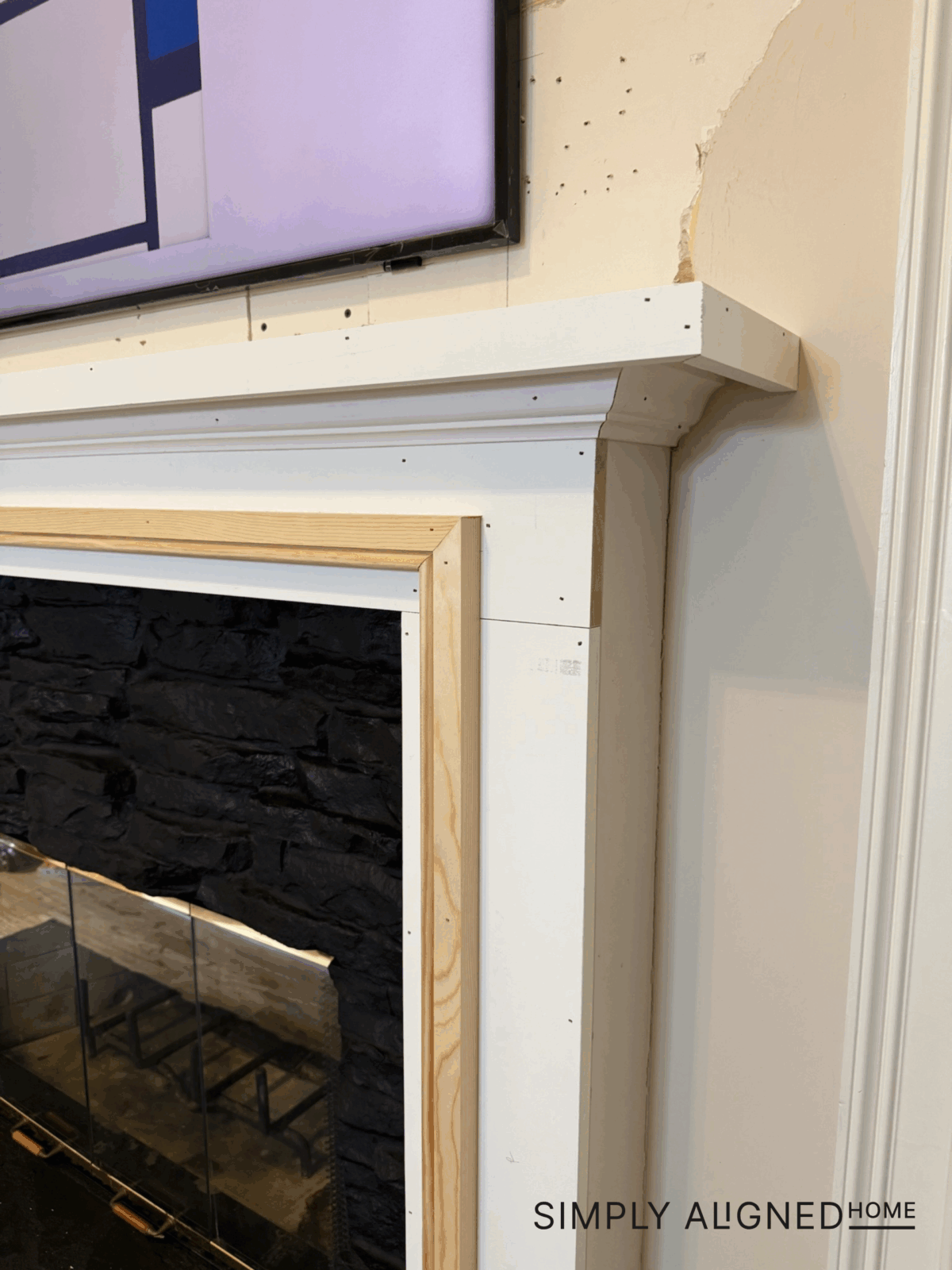 How to Update a Fireplace Surround with Wood and Trim - Simply Aligned Home