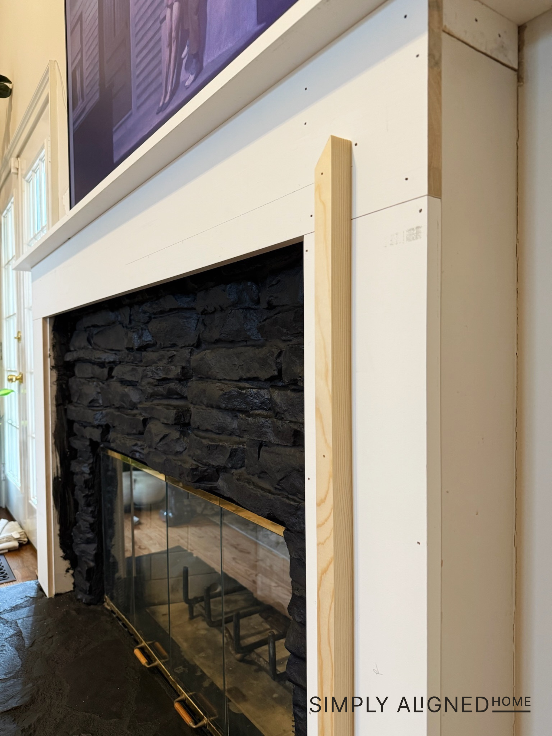 How to Update a Fireplace Surround with Wood and Trim - Simply Aligned Home